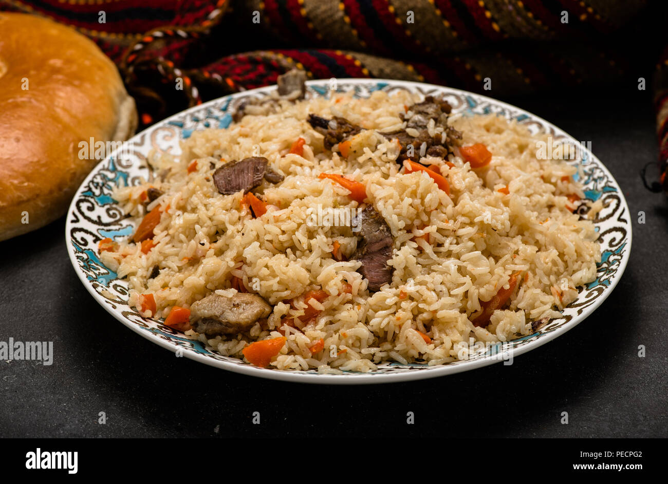 Pilaf on plate with oriental ornament and Traditional Asian breads ...