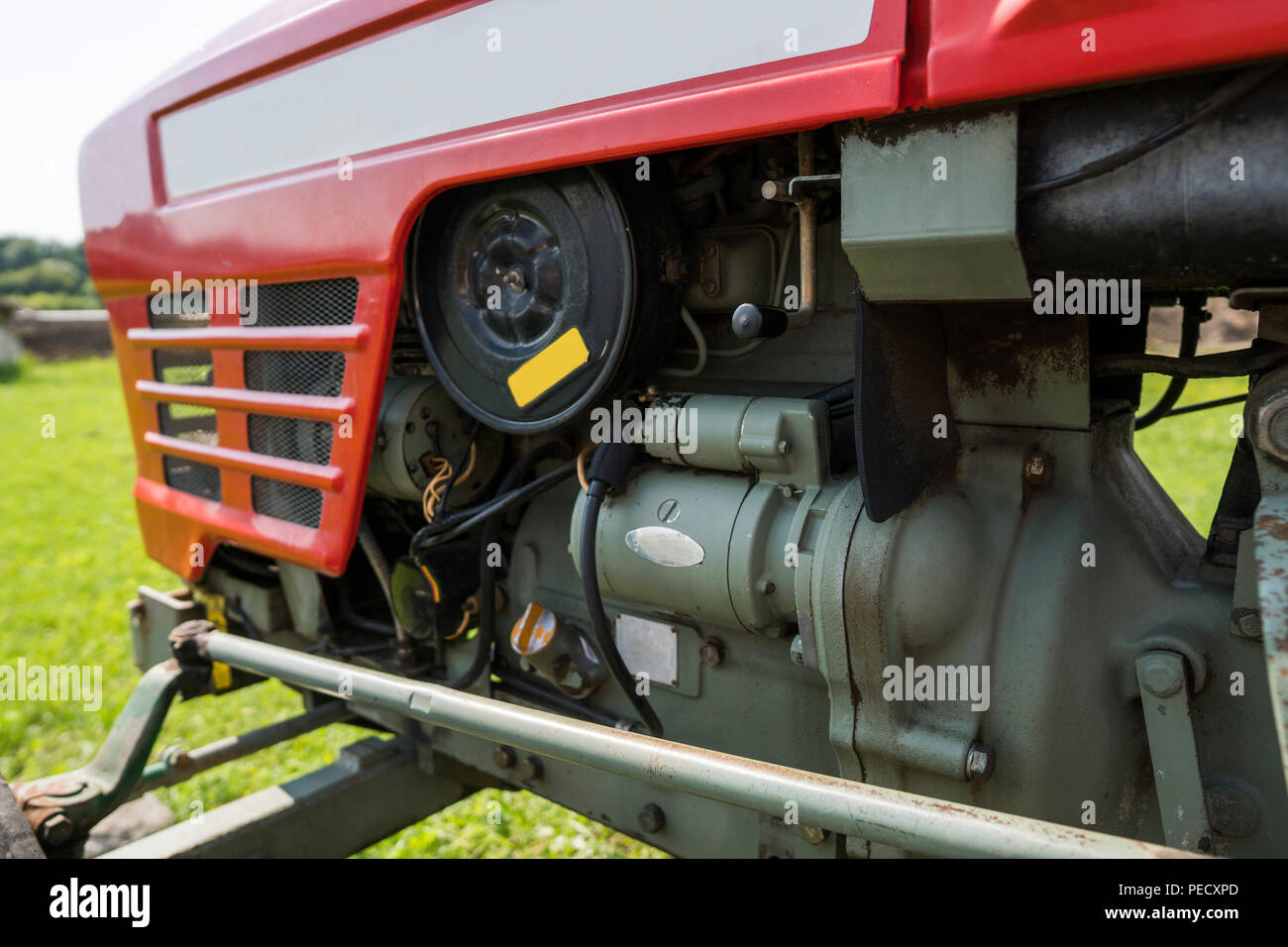 Motor details of the small mini red tractor Stock Photo - Alamy