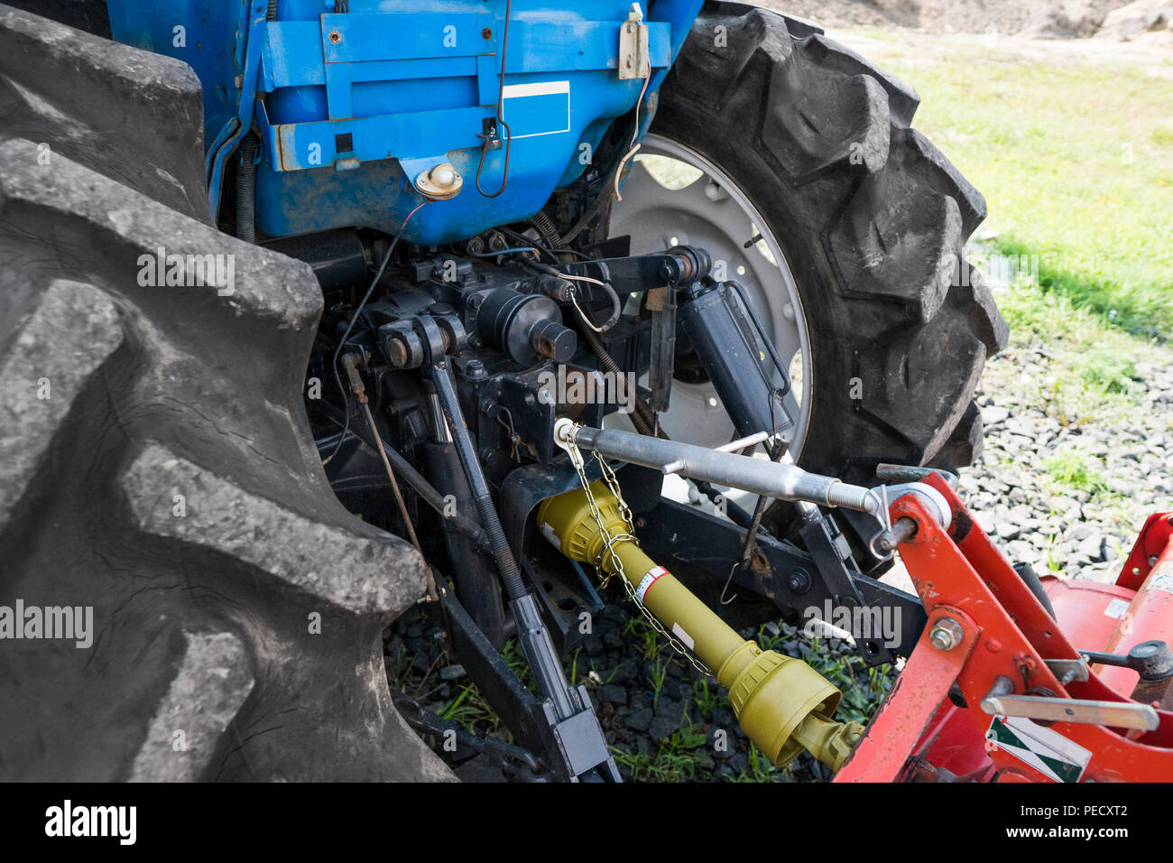 Close up on a mechanism of connection between small mini blue tractor ...