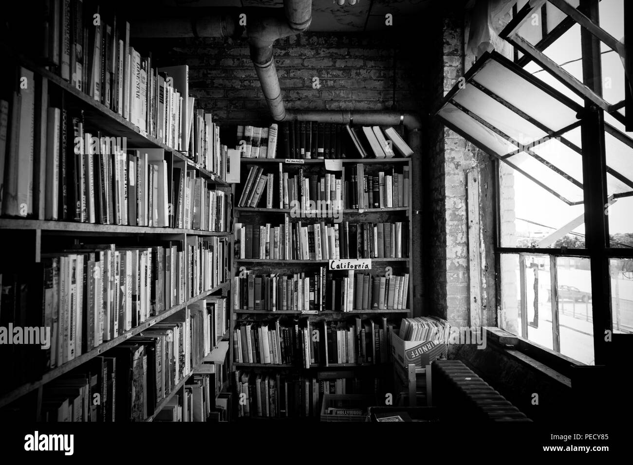 A black and white images of one of the endless rows of bookshelves at ...