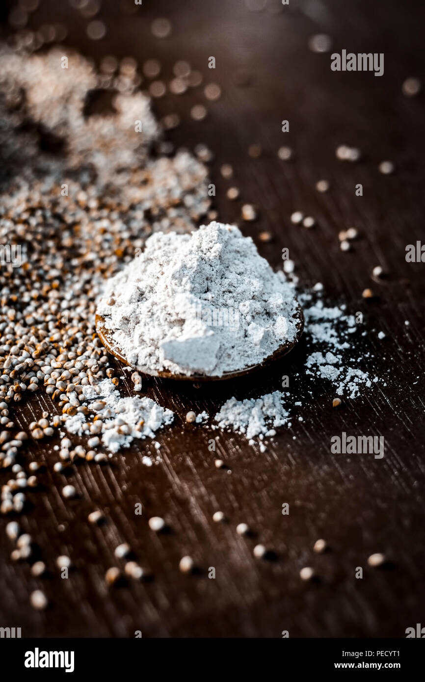 Close up of flour of pearl millet or bajra ka atta with raw pearl ...