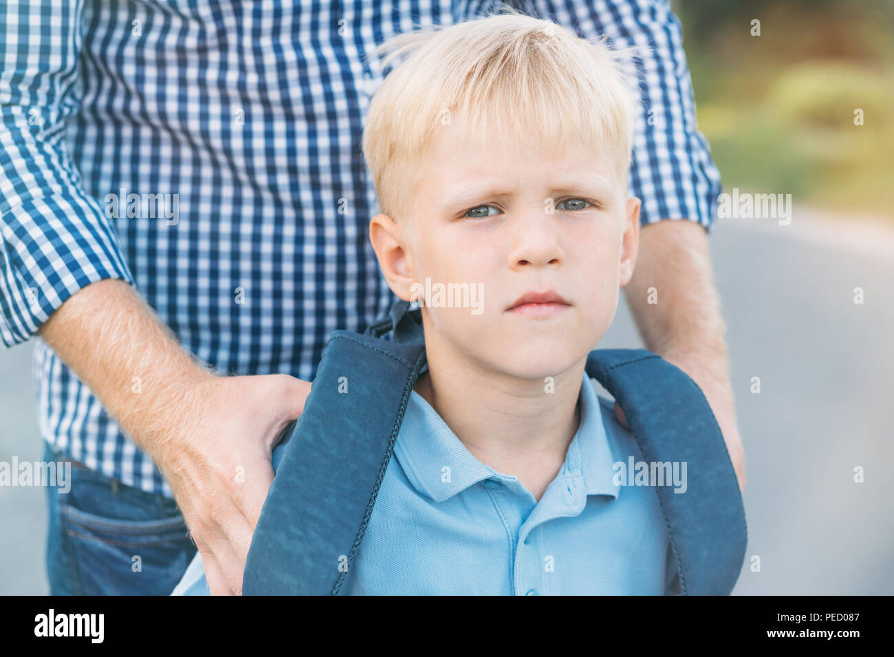 Father puts on backpack on his son. Back to school concept Stock Photo ...