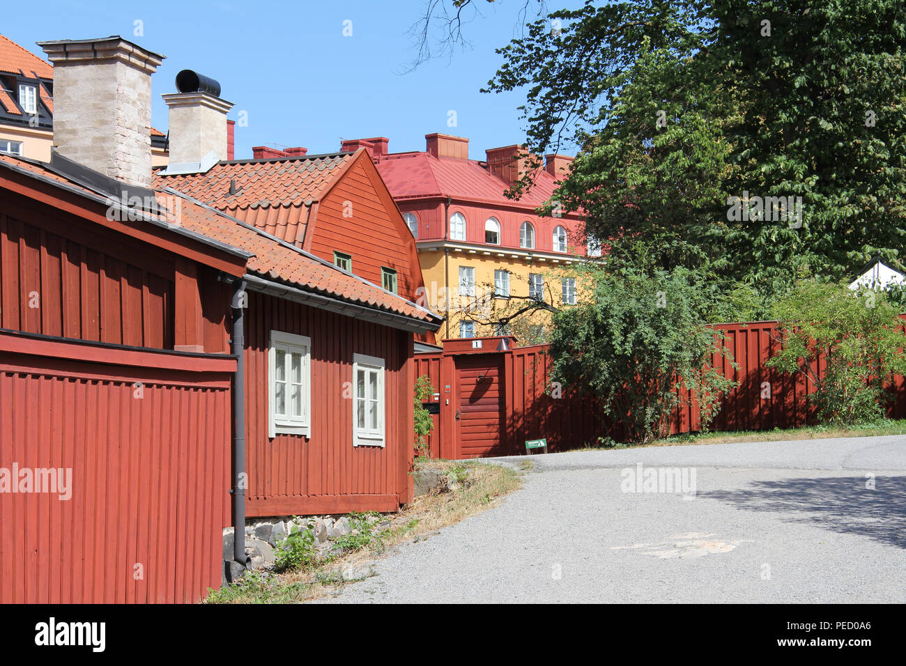 Street with wooden houses painted red on the isle of Södermalm ...