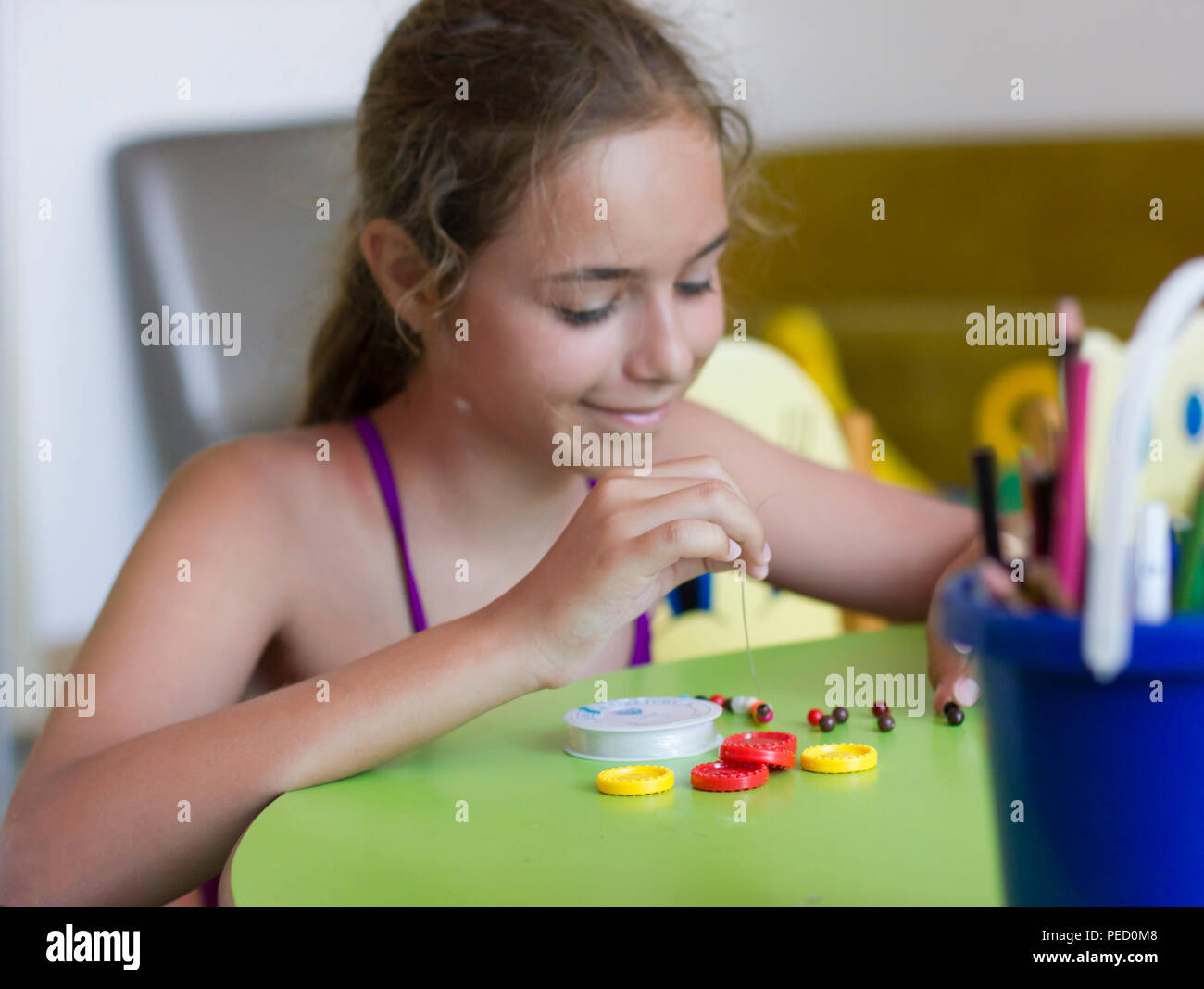 Child stringing beads hi-res stock photography and images - Alamy