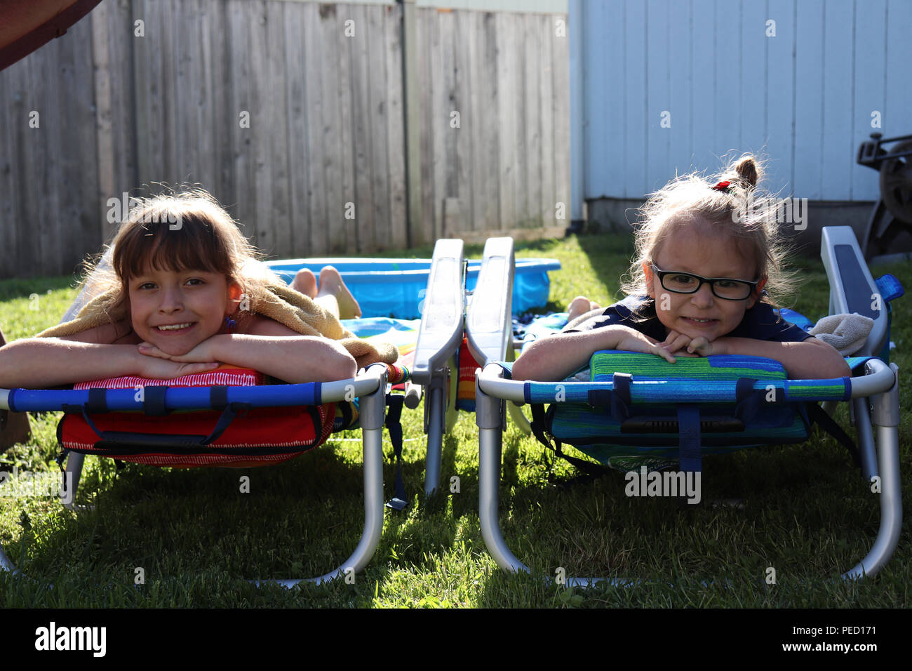 Two little girls enjoying the warm weather Stock Photo - Alamy