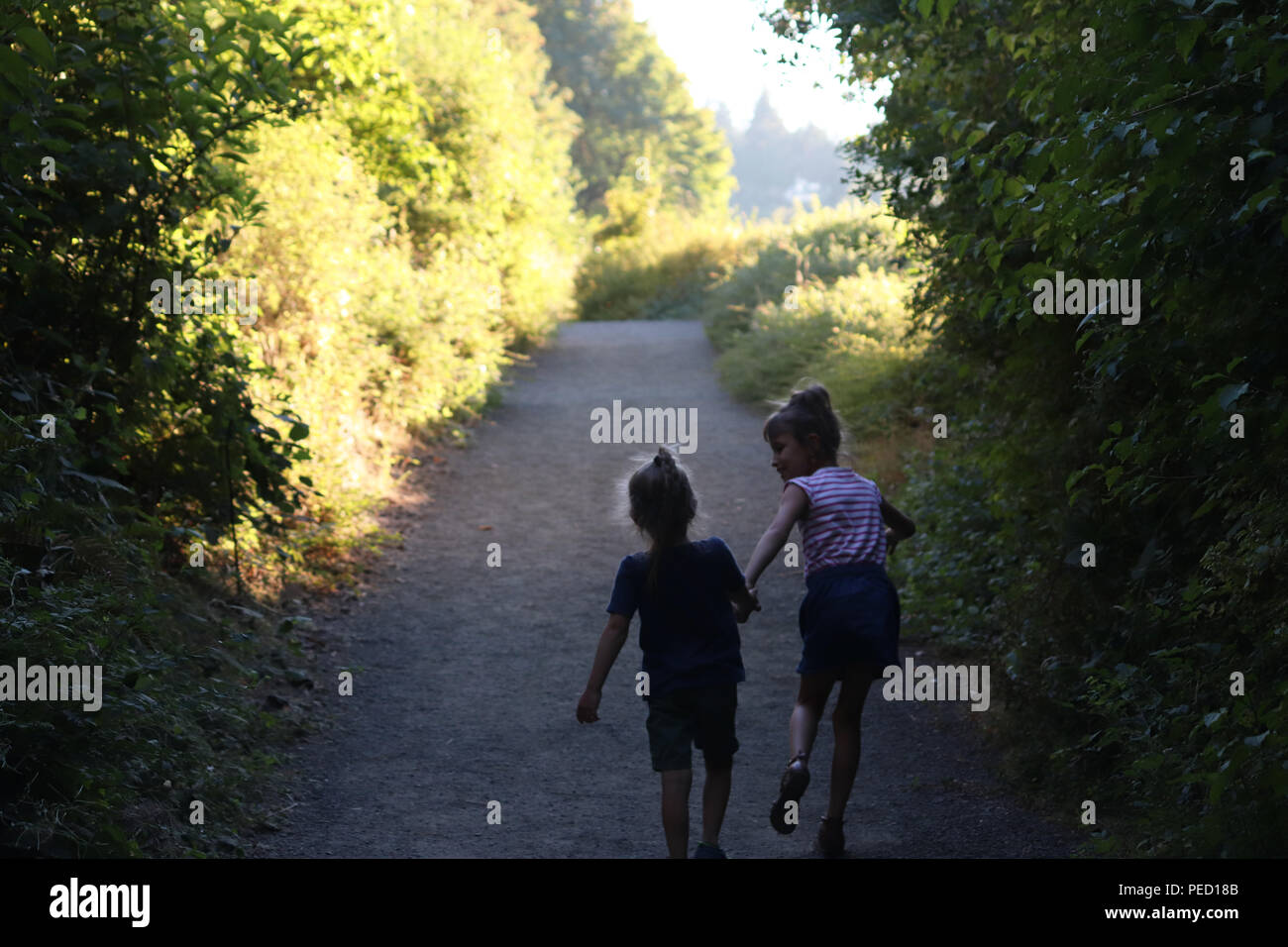 Two friends running Stock Photo - Alamy