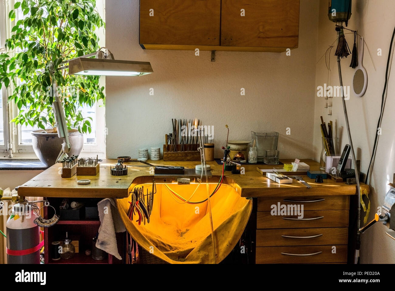 Equipment and tools of a goldsmith with polisher, tongs, pincers on ...