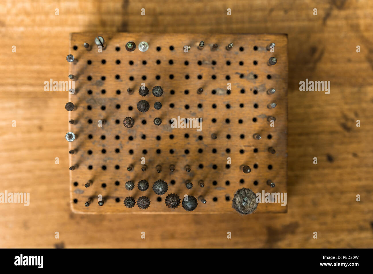Equipment and tools of a goldsmith with polisher on wooden working desk ...