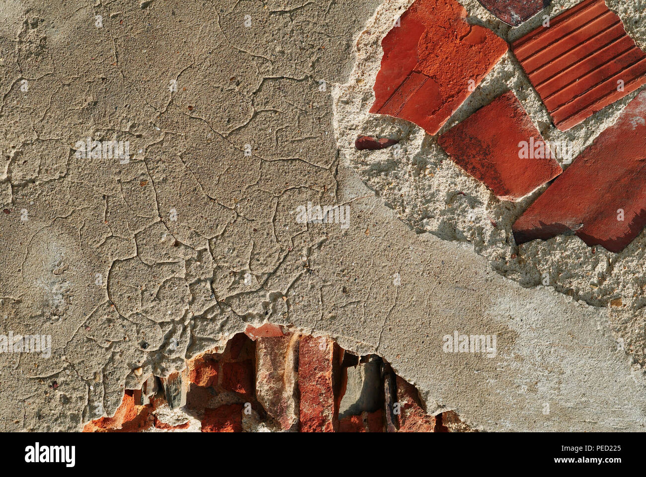 Fragment of a brick wall with the broken plaster Stock Photo - Alamy