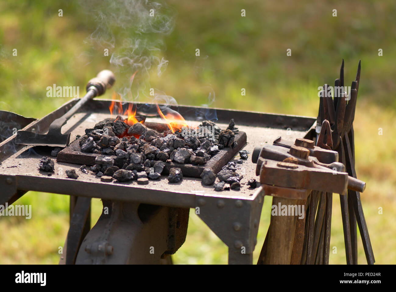 Photo of a smithy with burning coals and tools for forging Stock Photo ...