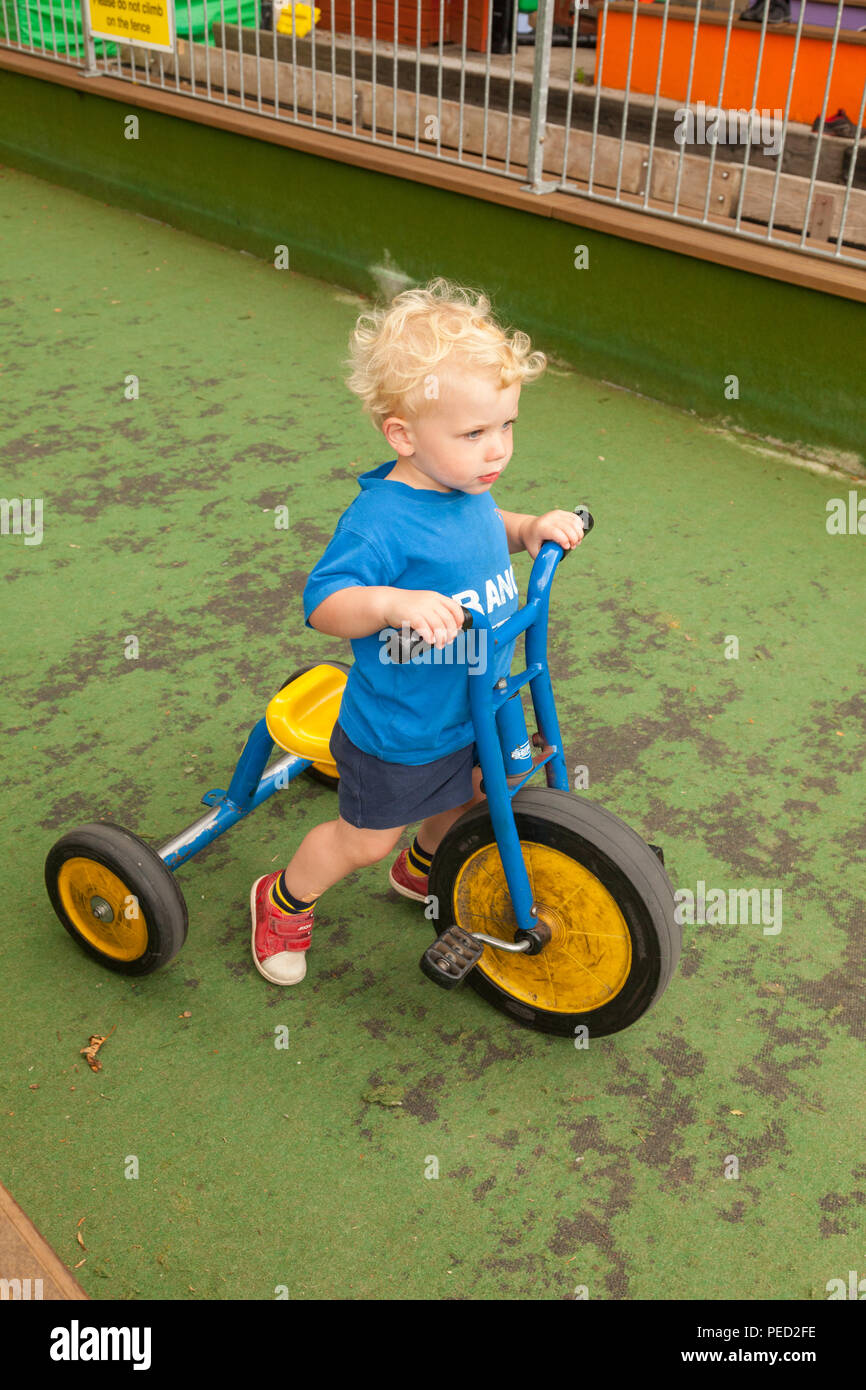 Two year on boy riding a trike at Woodlands Family Theme park, Totnes ...