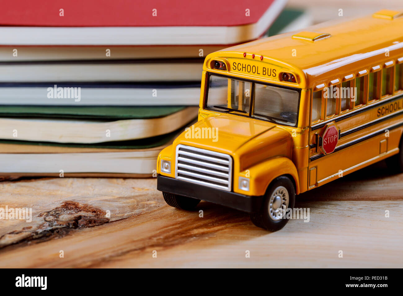 Back to school concept, colored pen and copybook, toy yellow school bus ...