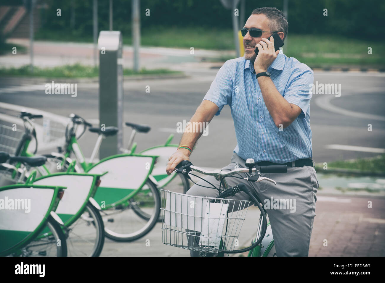 Man riding a bike in his way to work, concept of using city bike as ...