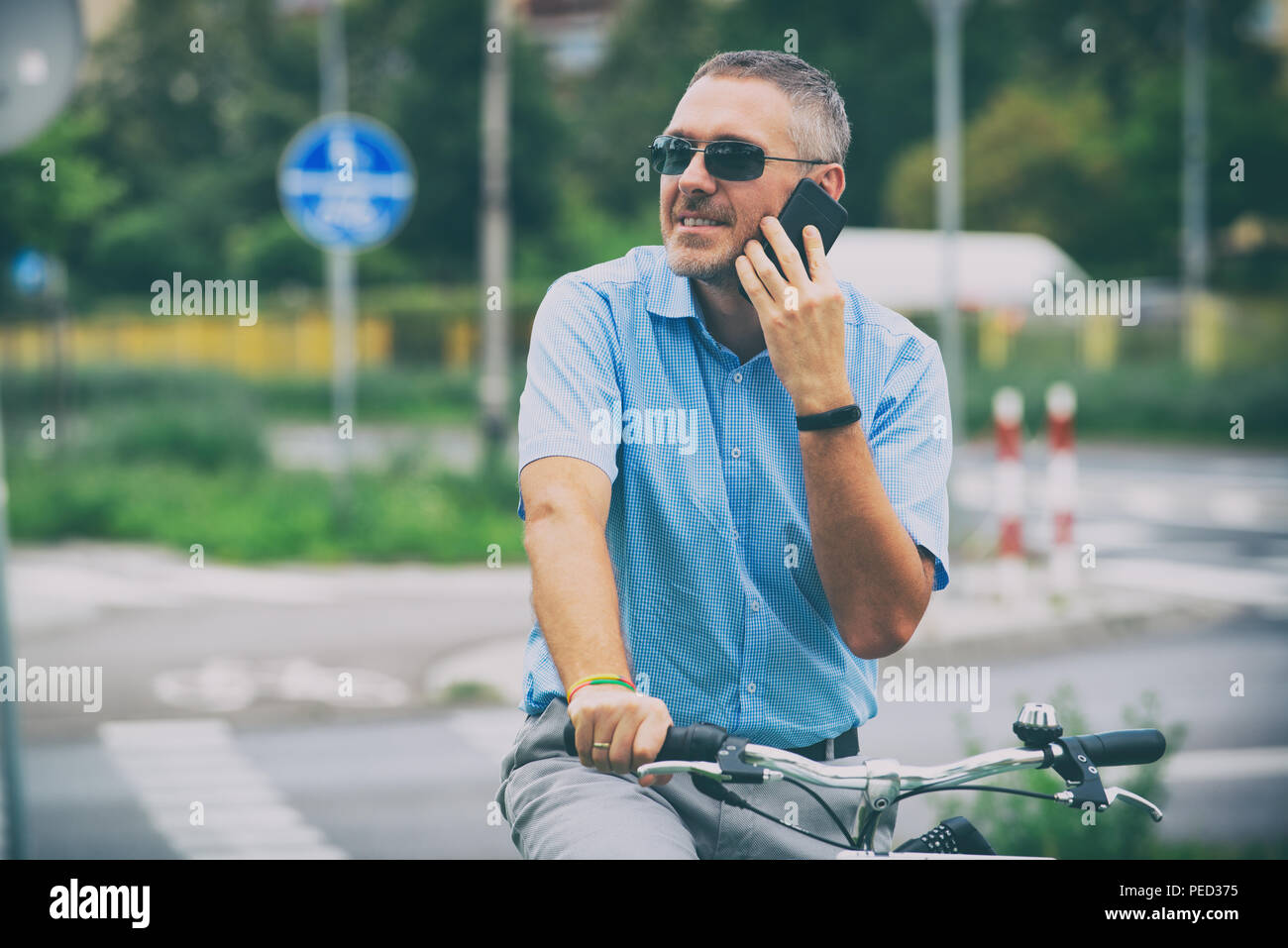 Man riding a bike in his way to work, concept of using city bike as ...