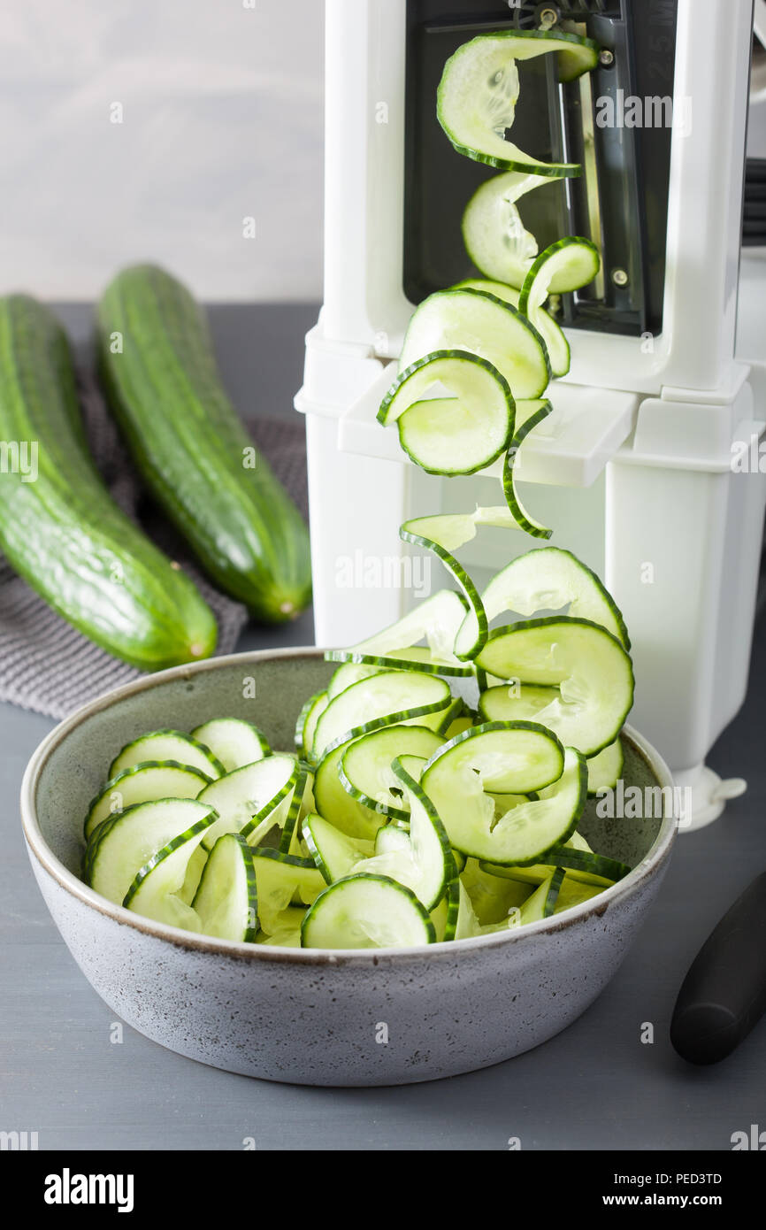 spiralizing cucumber vegetable with spiralizer Stock Photo - Alamy