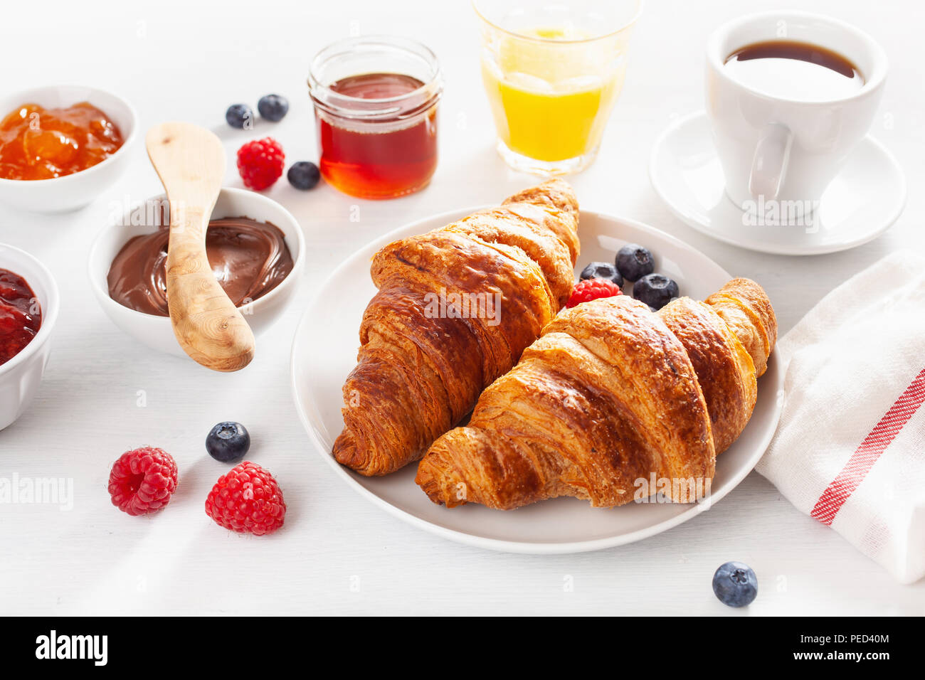Continental breakfast with croissant, jam, chocolate spread and coffee ...