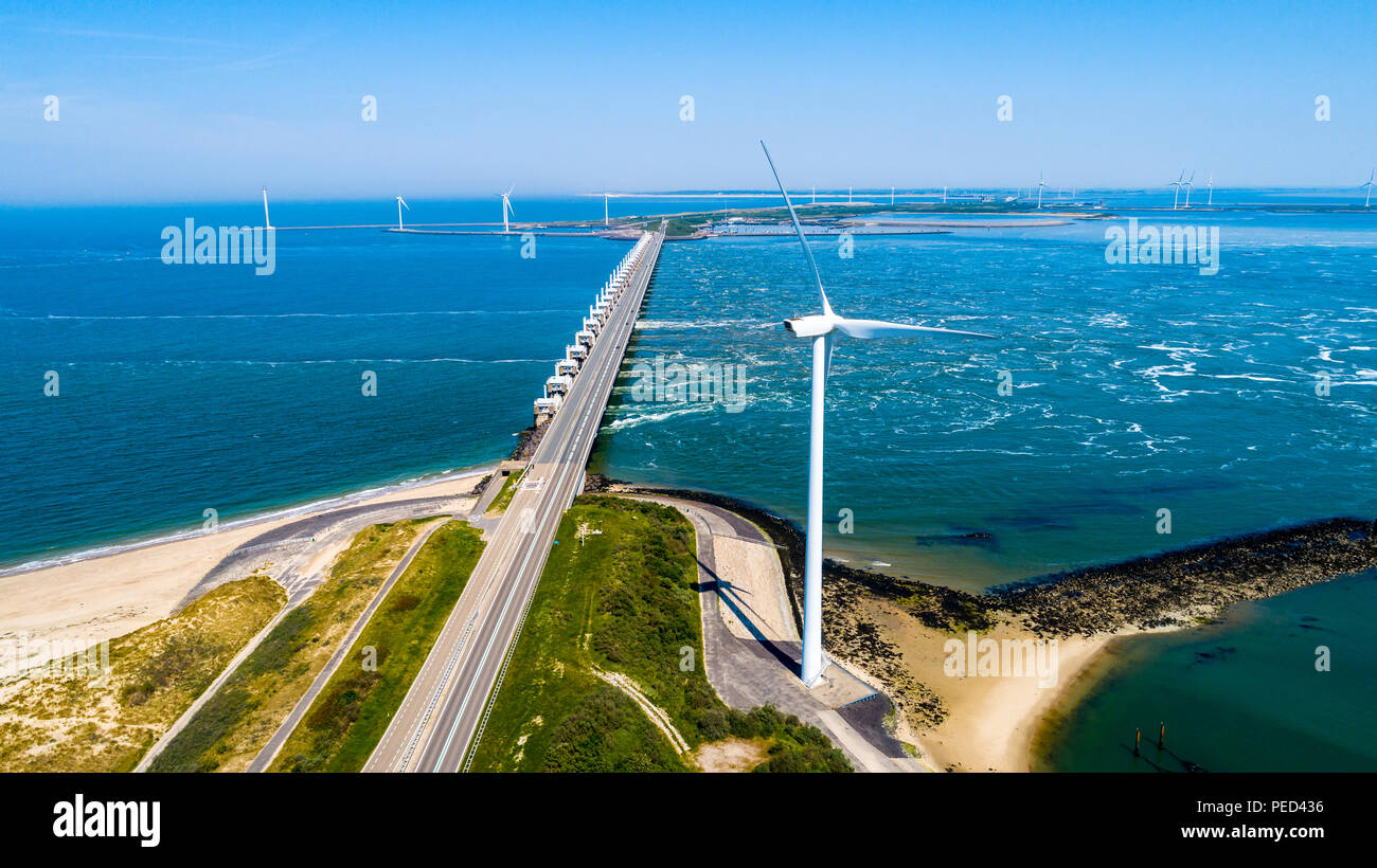 Oosterschelde flood barrier with windmills in the Netherlands at the ...