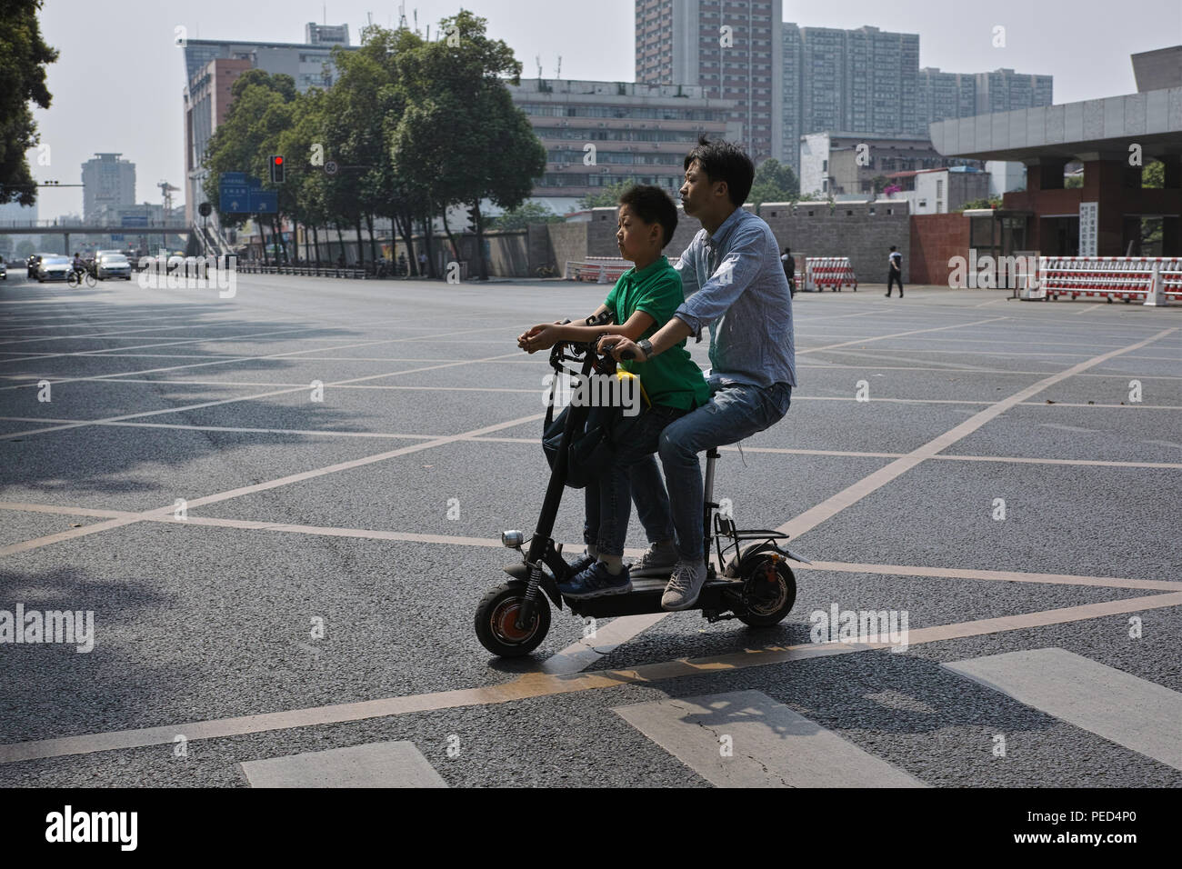 two people riding a new type of bike in Chengdu downtown, Sichuan ...