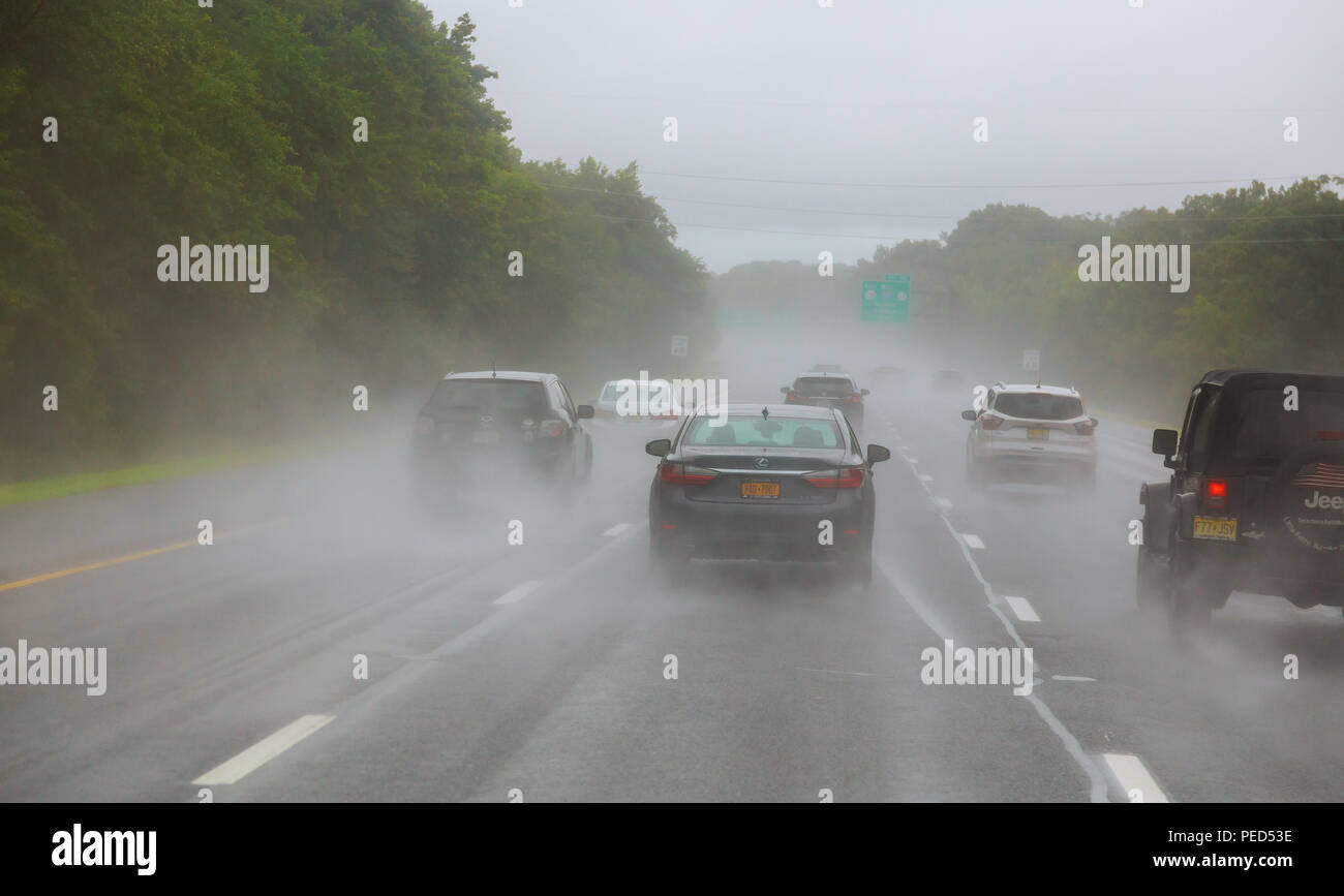 Traffic on highway on a foggy rainy day. Risk of accident during heavy ...