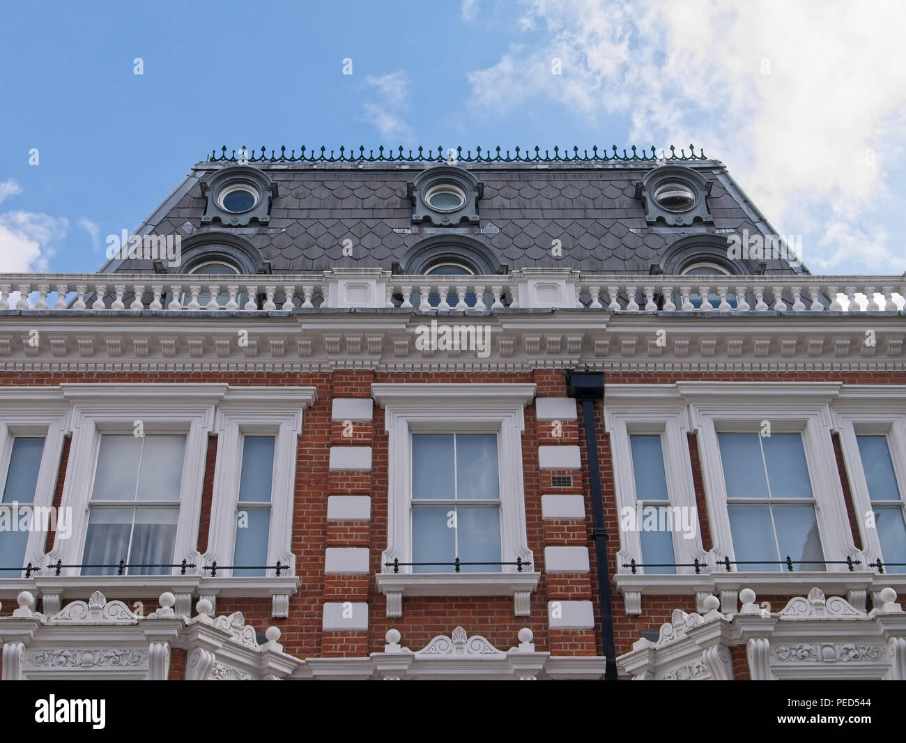 Victorian townhouse exterior in London. Steep pitch terracotta tiled ...