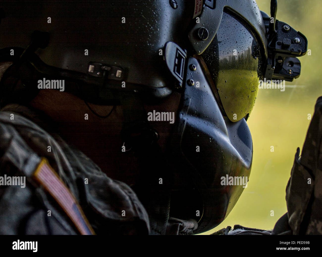 An Army Reserve flight engineer looks out of a window of a Chinook ...