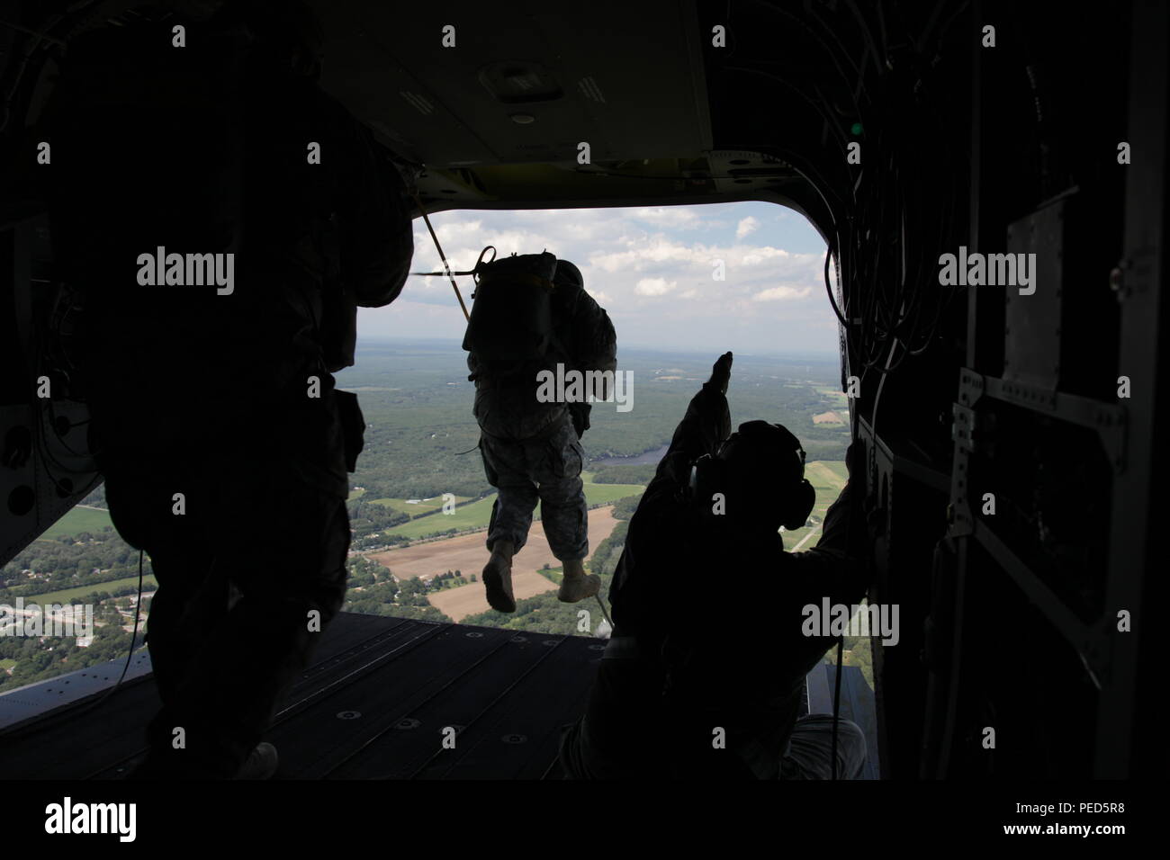 U.S. Army Sgt. 1st Class Matthew Fiore, JCSE, jumps from a CH-47 ...