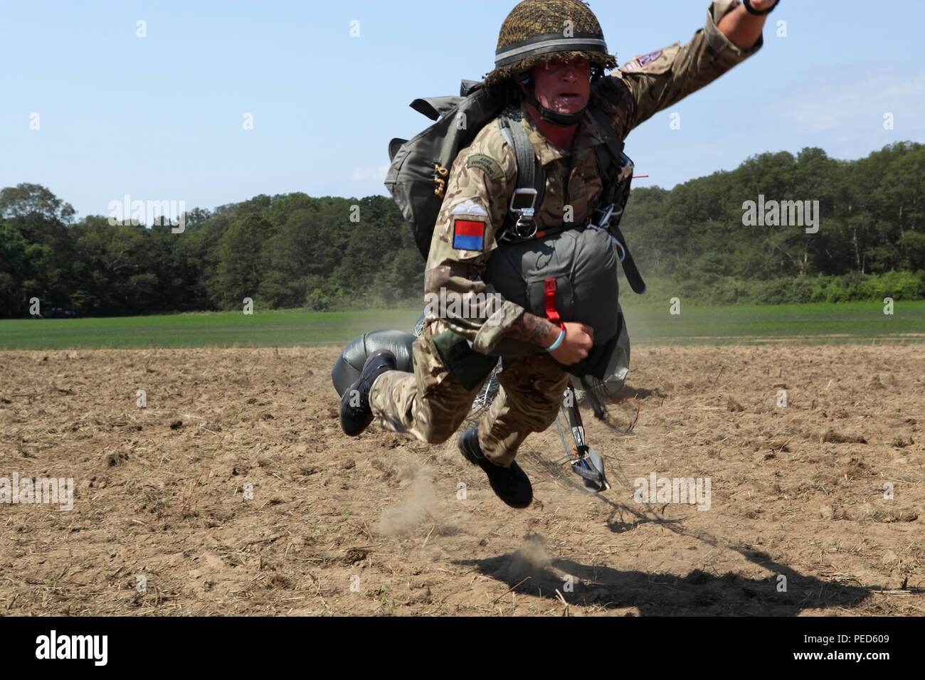 A British paratrooper runs toward the "X" on the drop zone during ...