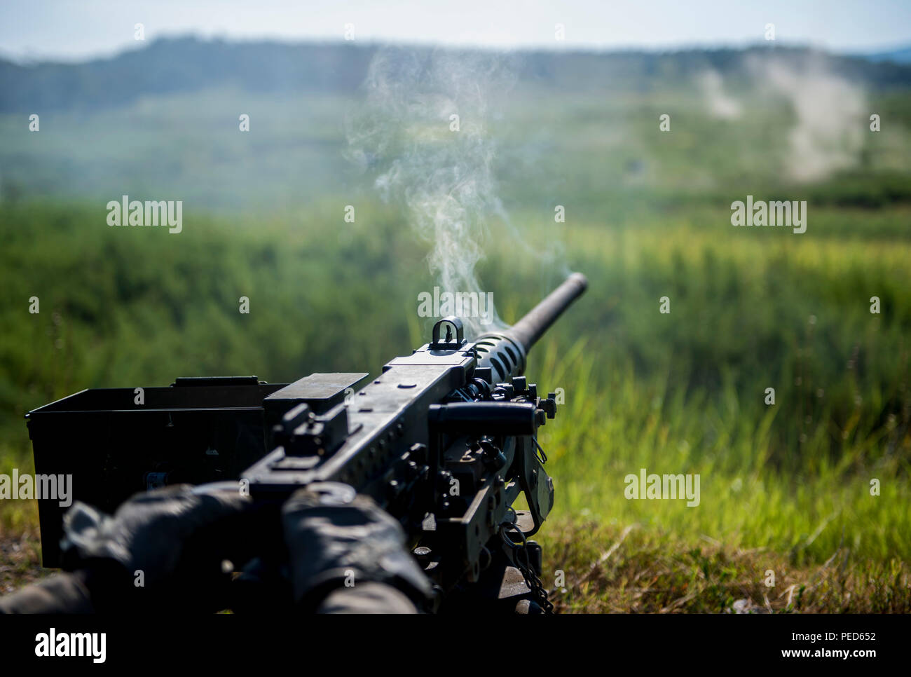 Hot steam rises from the barrel of an M2 Browning .50-caliber machine ...