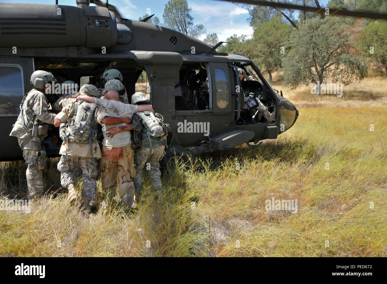 Soldiers from the 325th Combat Support Hospital move casualties to a HH ...