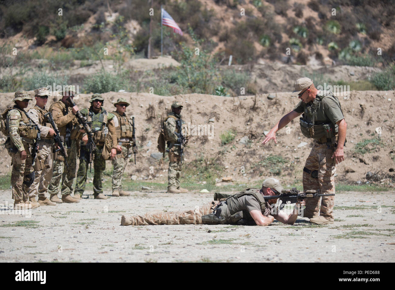 U.S. and Canadian combat camera personnel practice prone shooting ...