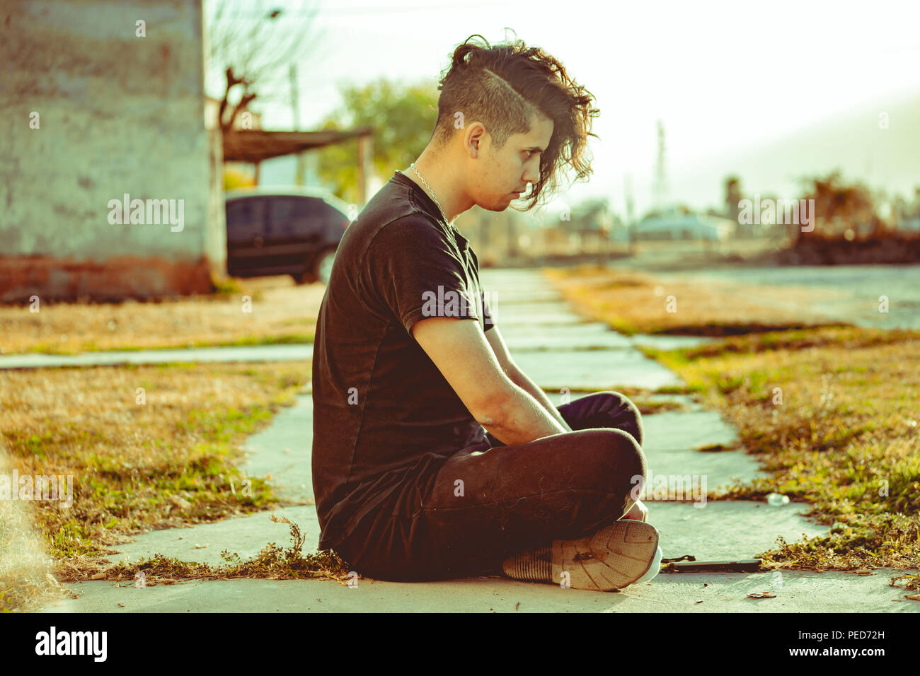 Man sitting in road thinking Stock Photo - Alamy