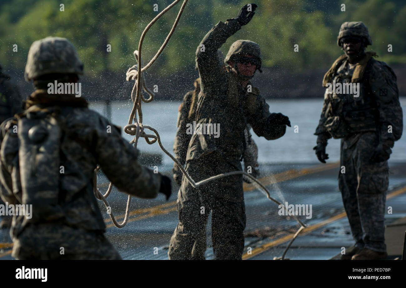 An Army Reserver Soldier tosses a rope to another Soldier to connect ...