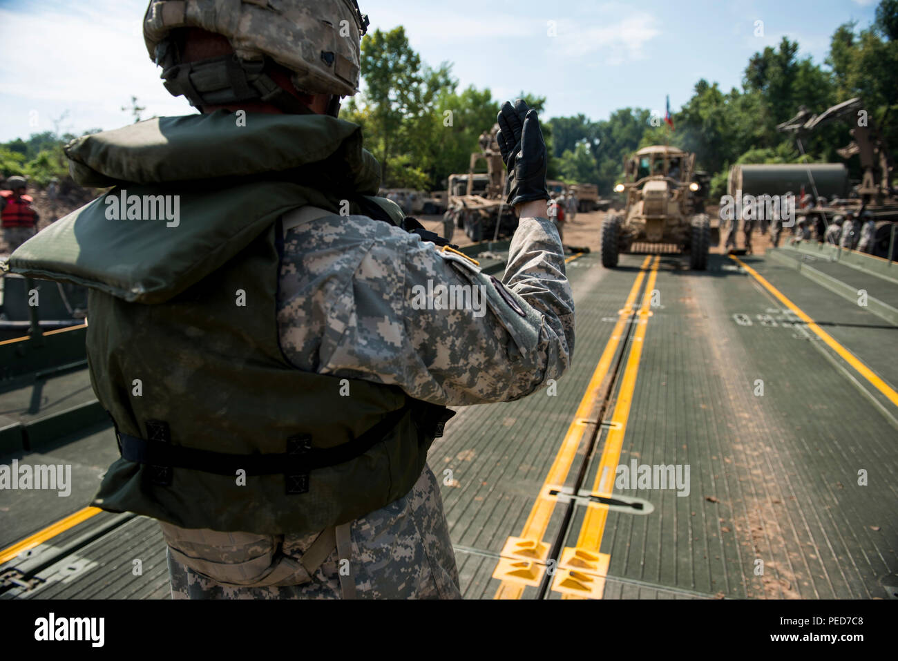 A convoy rides across a finished modular floating bridge assembled by ...