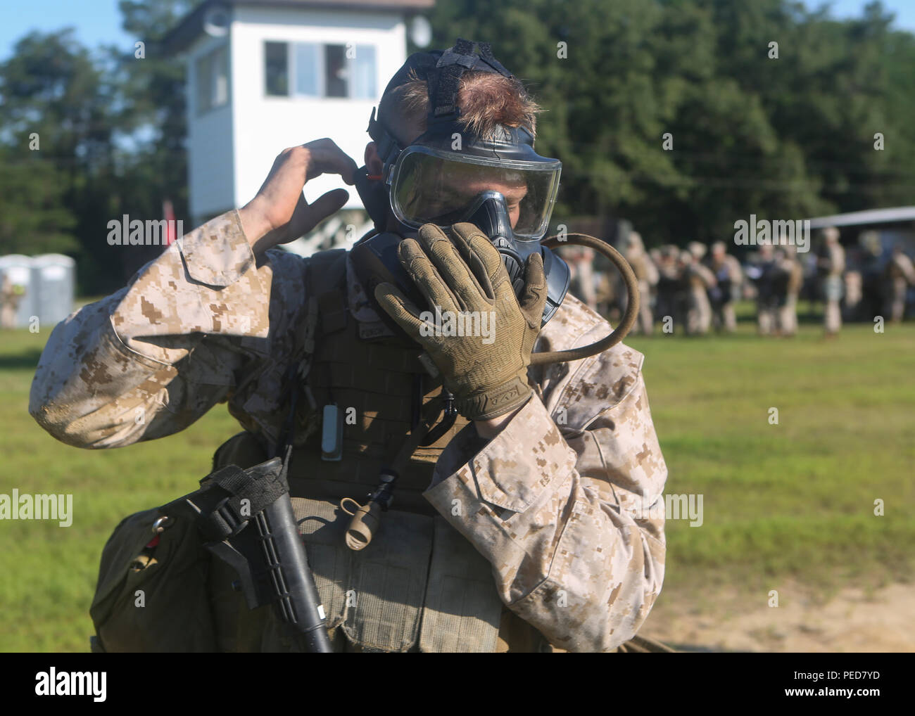 A Marine with 2nd Combat Engineer Battalion dons his gas mask in ...