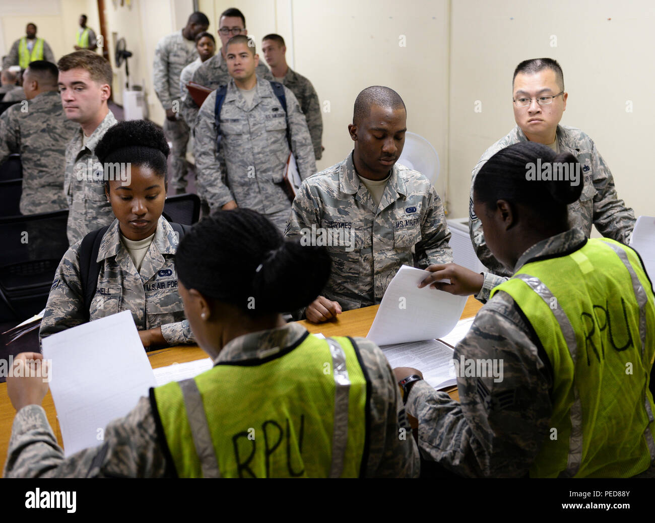 U.S. Air Force Airmen go through a reception processing unit as part of ...