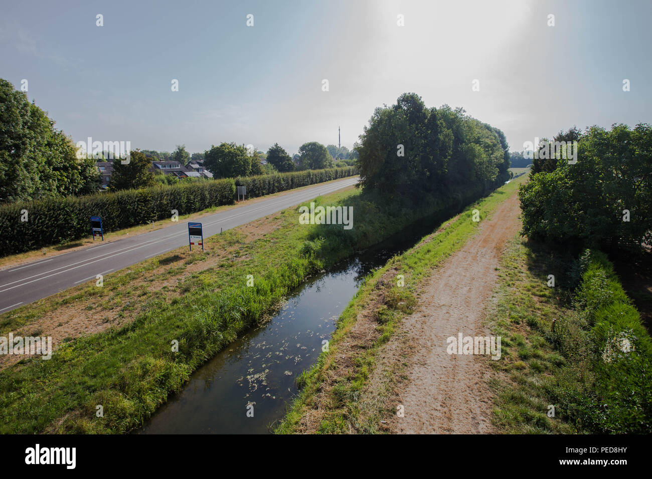 A road leads to a quiet residential neighbourhood area with traditional ...