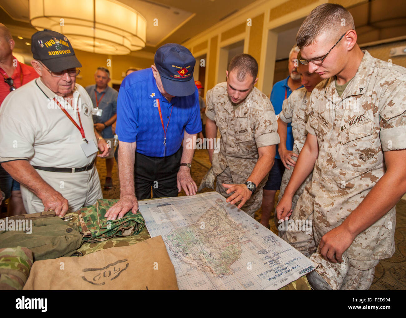 Veterans of 4th Marine Division (4th MARDIV) view a map of Iwo Jima ...
