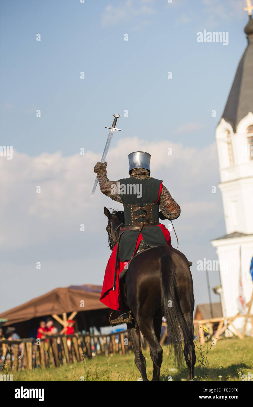 Bulgar, Russian Federation - August 2018, - a man in iron armor sits on ...