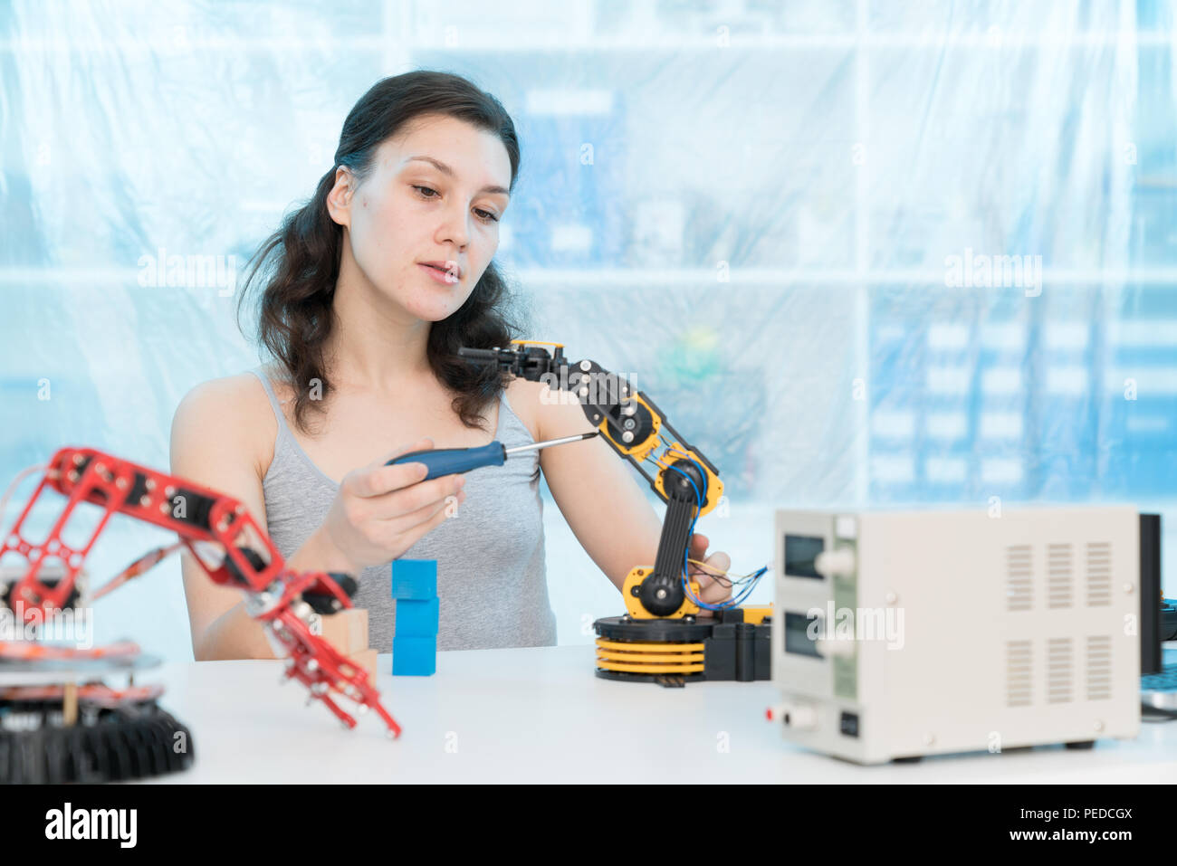 girl in a University laboratory is experimenting with a robot Stock ...