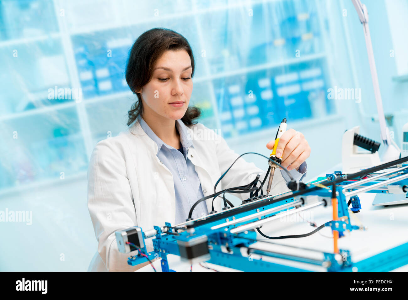 Student girl in electronics laboratory, experiment with microcontroller ...