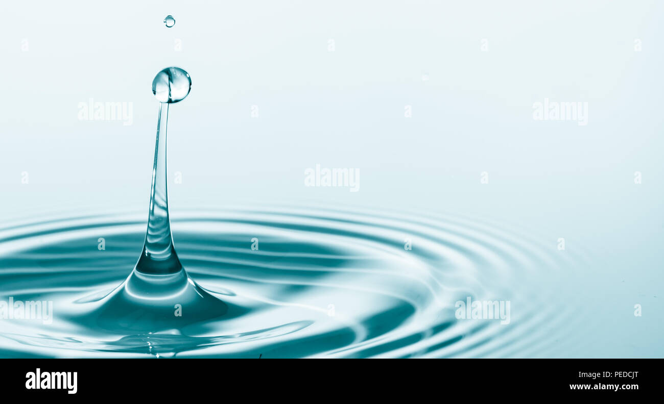 Water drop falling into water making a perfect droplet splash Stock ...