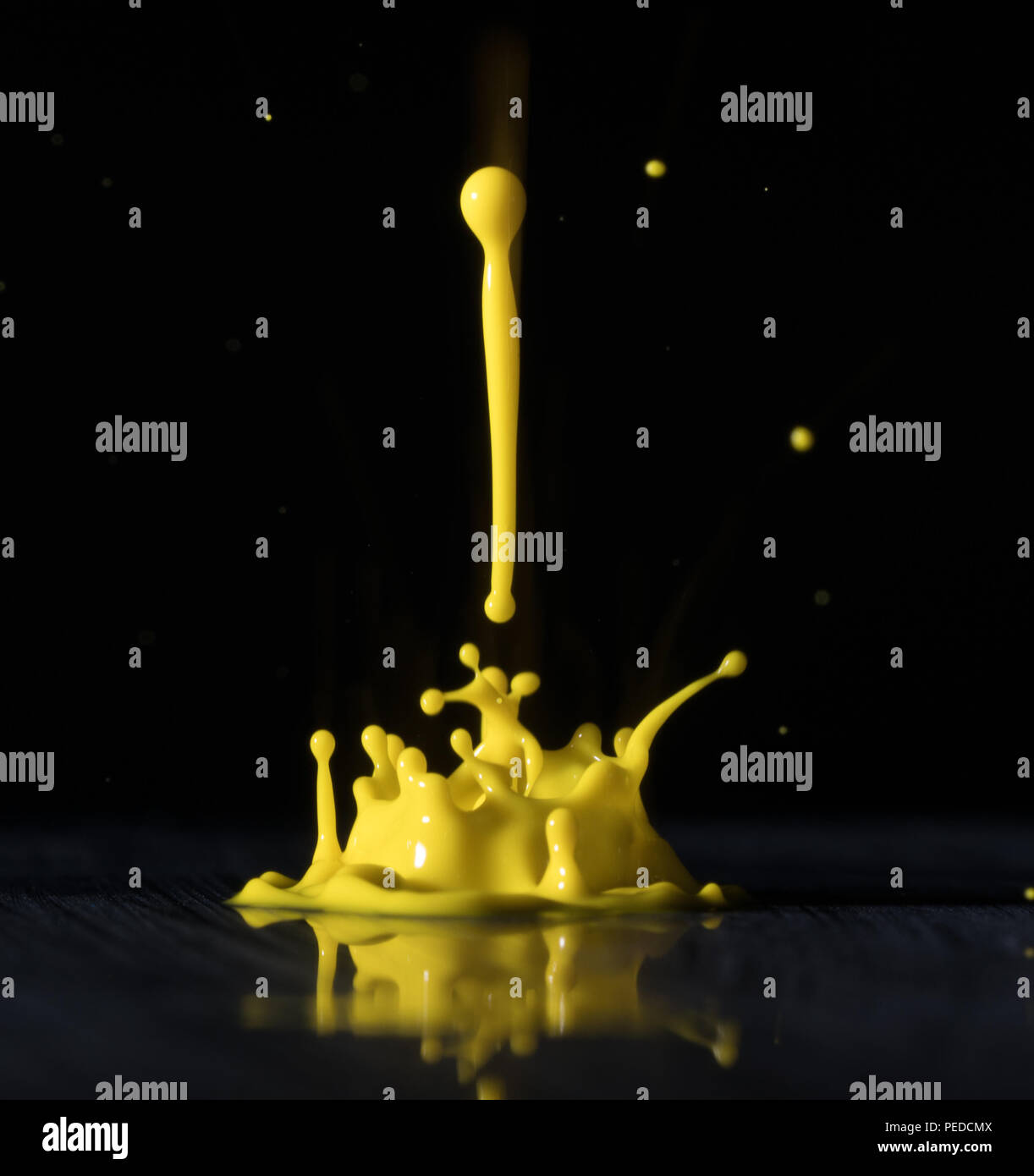 Yellow paint, ink splash on black background Stock Photo - Alamy