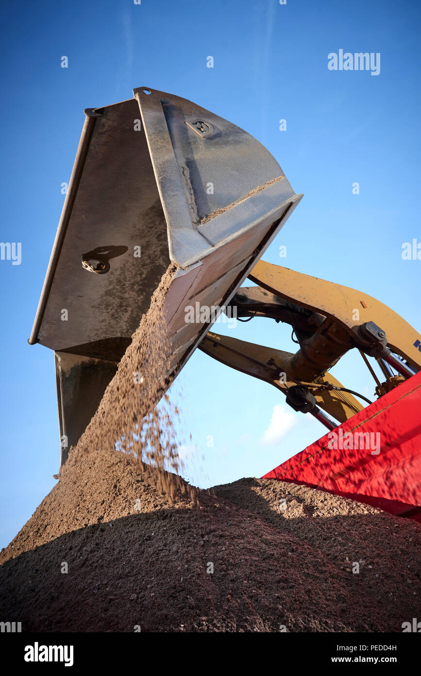 Excavator moving sand Stock Photo - Alamy