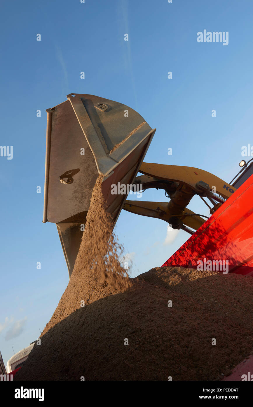Excavator moving sand Stock Photo - Alamy