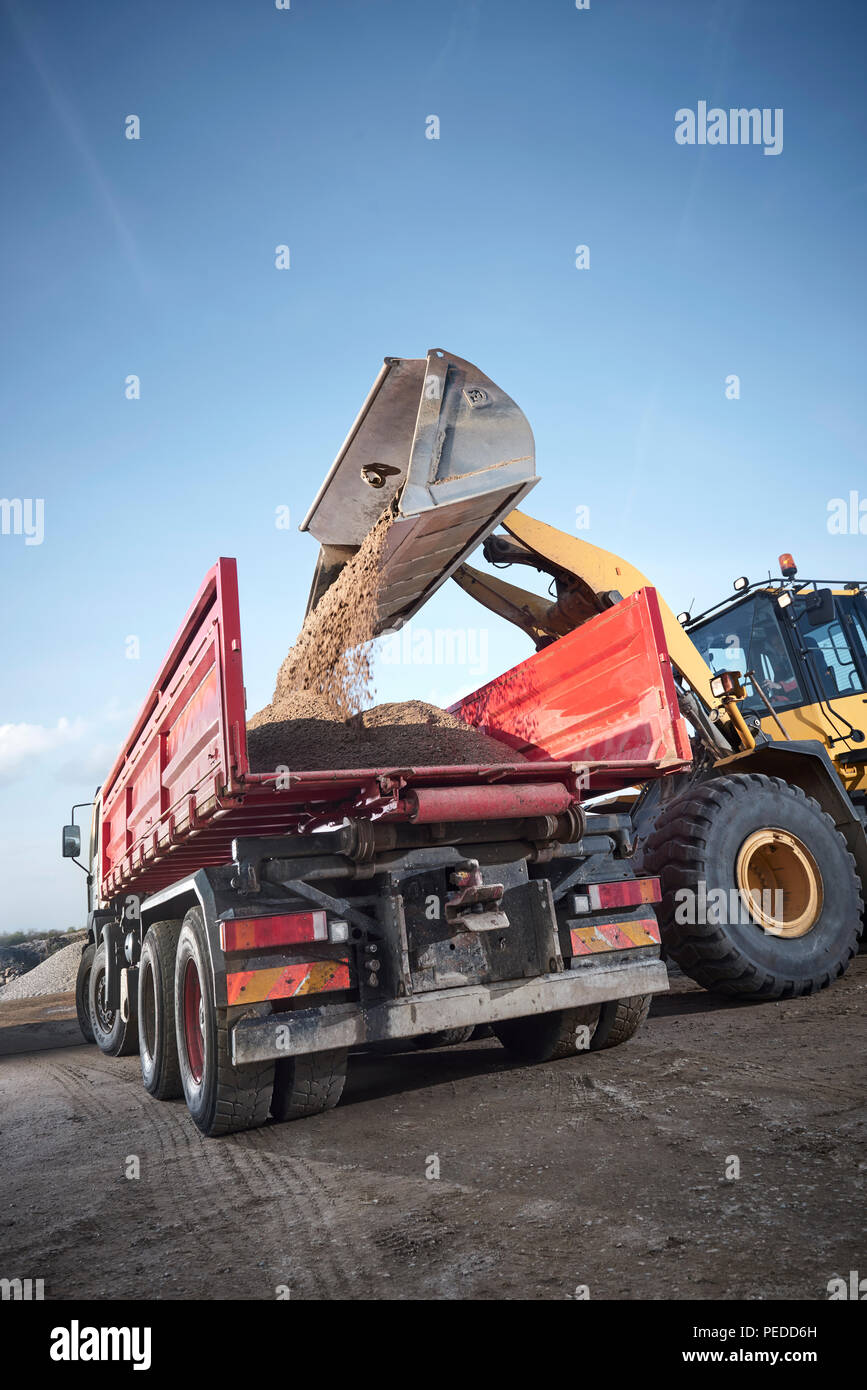 Excavator moving sand Stock Photo - Alamy