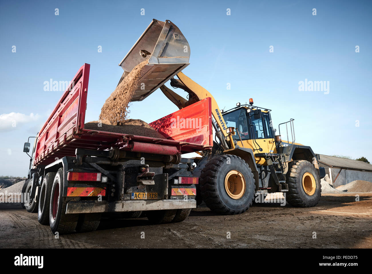 Excavator moving sand Stock Photo - Alamy