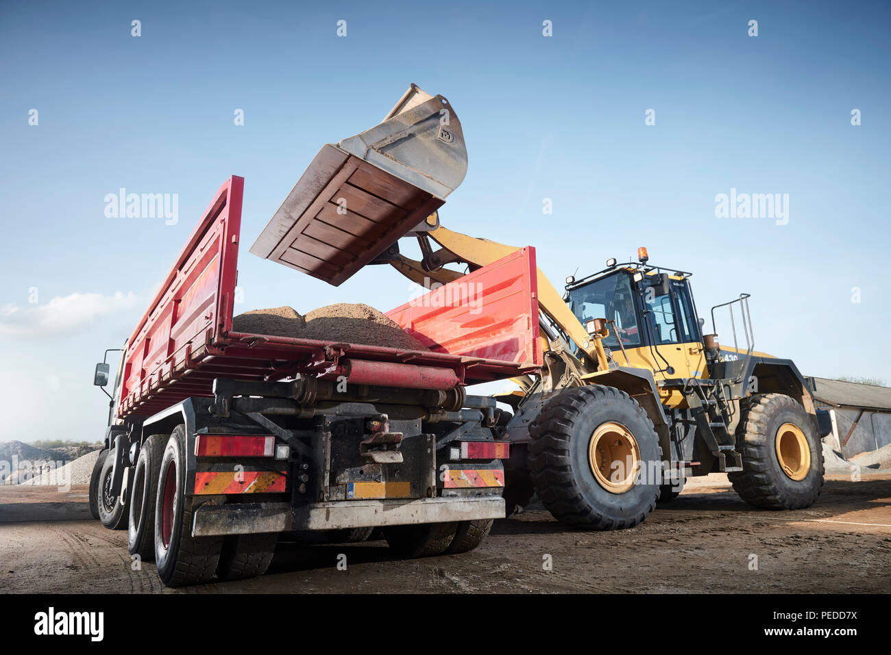 Excavator moving sand Stock Photo - Alamy