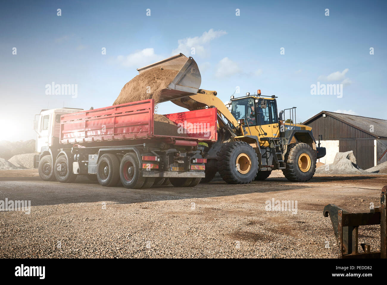Excavator moving sand Stock Photo - Alamy