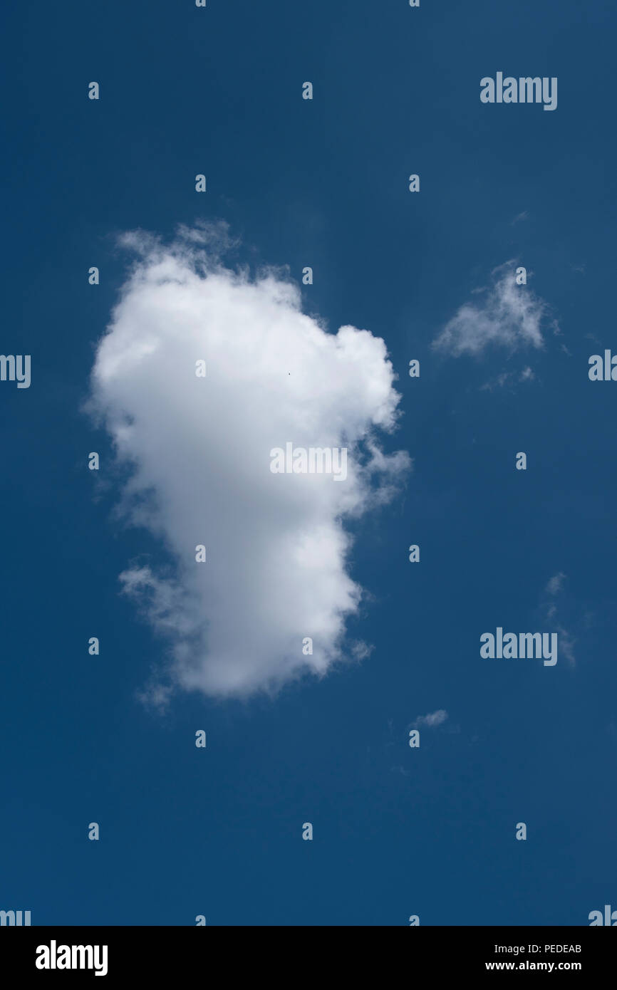 Single white fluffy cloud against deep blue sky hi-res stock ...