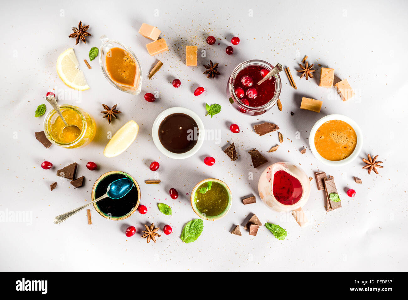 Various sweet sauces, toppings and syrups - lemon, orange, caramel ...